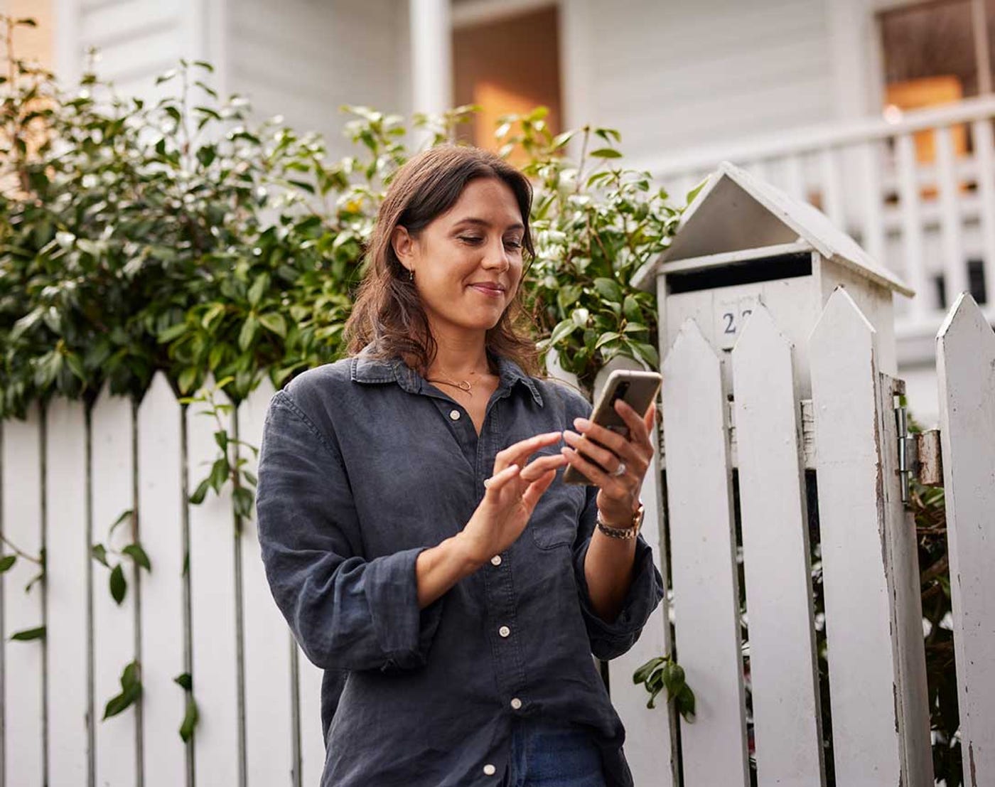 Woman looking at Energy IQ app on phone