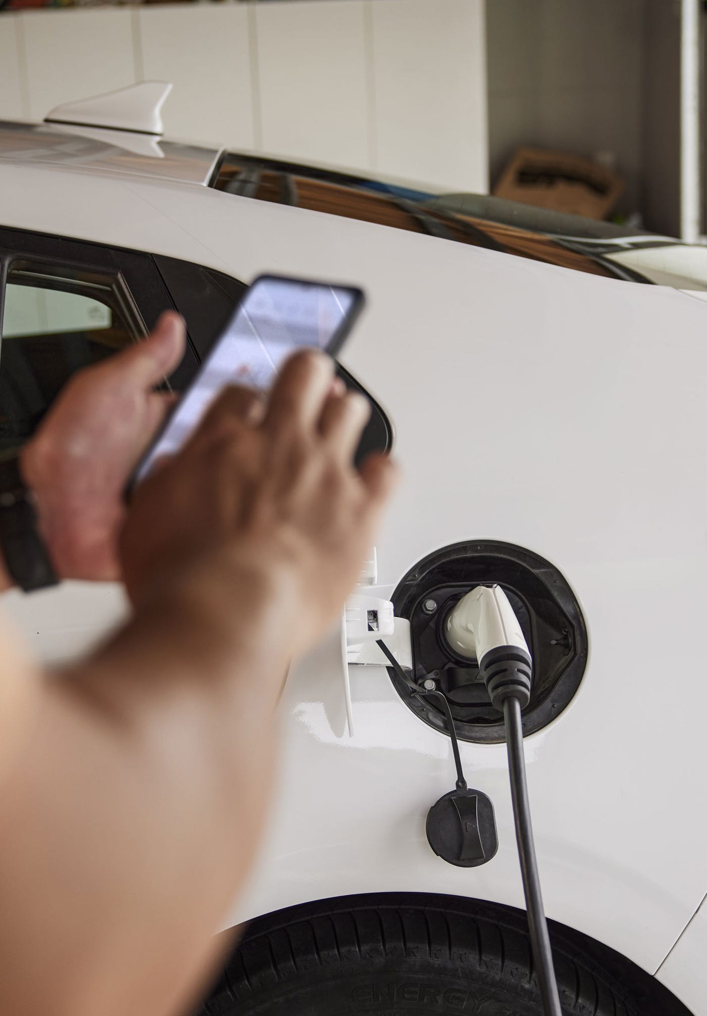 Man monitoring his electric vehicle